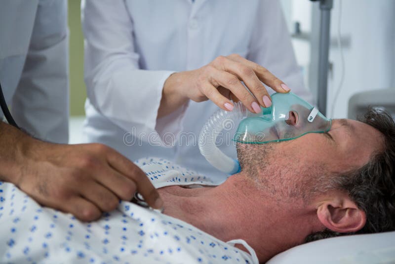 Doctor Placing an Oxygen Mask on the Face of a Patient Stock Image ...
