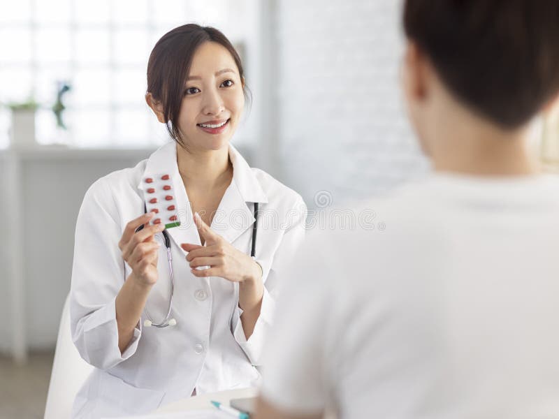 Doctor is Pointing To Drug Tablet and Introducing To Patient Stock ...