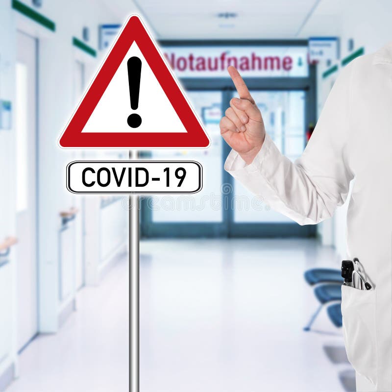 Doctor Points with His Finger at a Warning Covid-19 Sign Stock Image ...