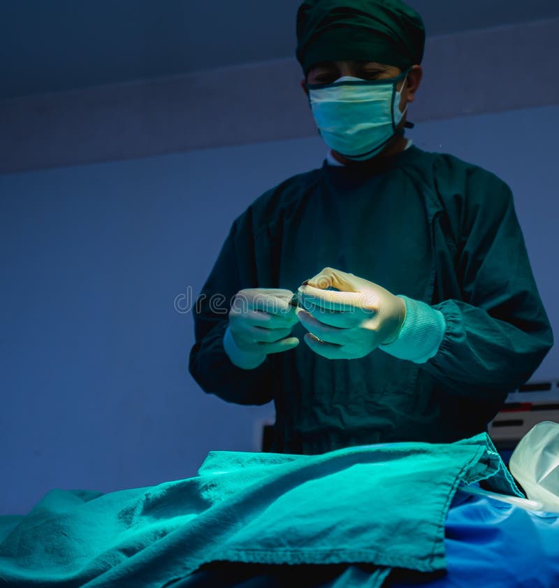 Doctor Prepare Scalpel Before Surgery In Operating Room Stock Image