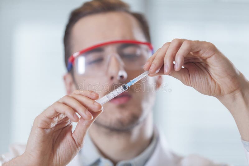 Doctor Preparing a Syringe for Injection Stock Photo - Image of tubes ...