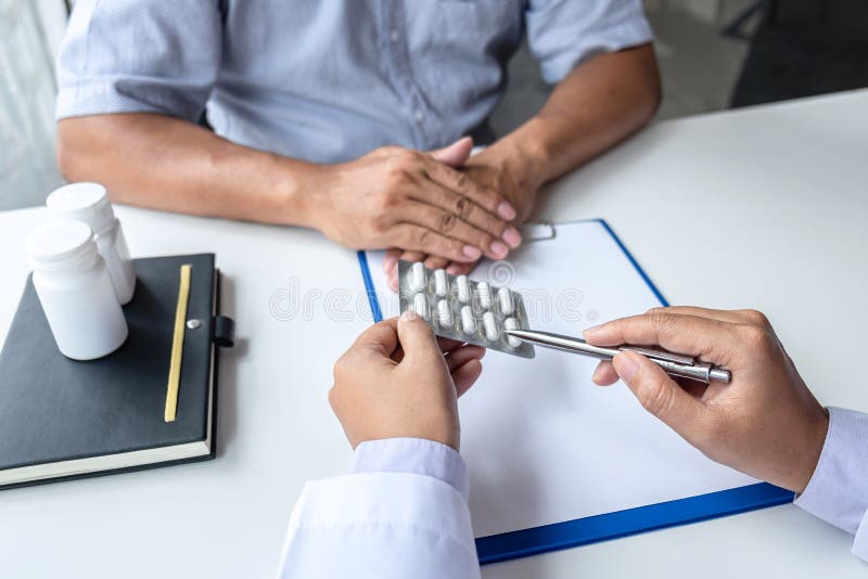 Doctor Presenting with Patient and Checking Results on Report and ...