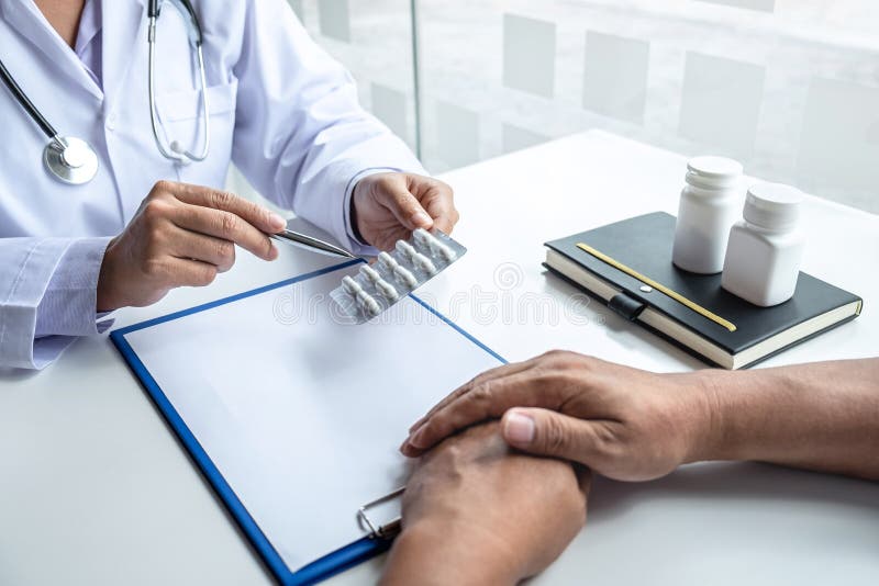 Doctor Presenting with Patient and Checking Results on Report and ...