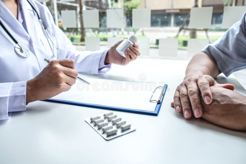 Doctor Presenting with Patient and Checking Results on Report and ...