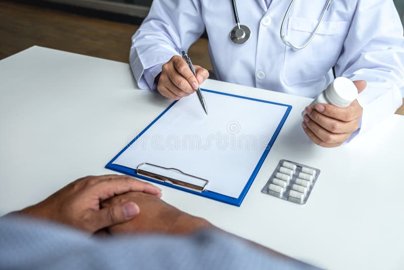 Doctor Presenting with Patient and Checking Results on Report and ...