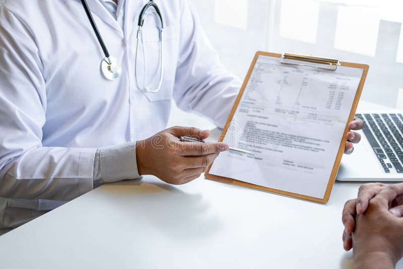 Doctor Presenting with Patient and Checking Results on Report and ...