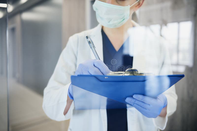 Doctor in Face Mask Making a Medical Exam Stock Photo - Image of mask ...