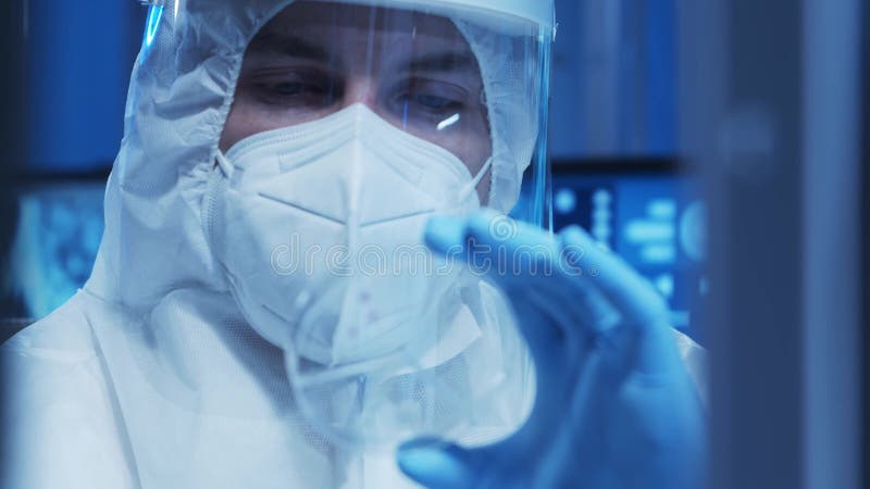 Doctor in Protective Suit is Doing a Science Experiments and Developing ...