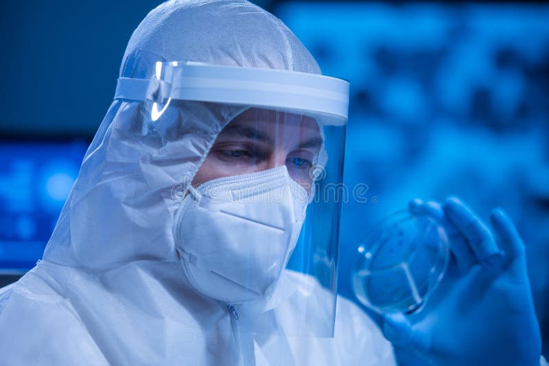 Doctor in Protective Suit is Doing a Science Experiments and Developing ...