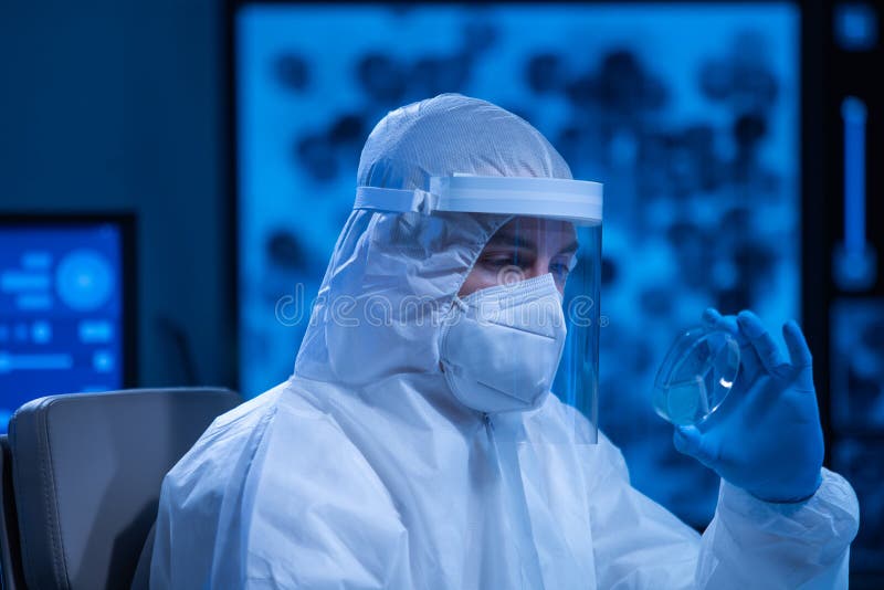 Doctor in Protective Suit is Doing a Science Experiments and Developing ...