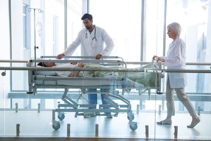 Doctor Pushing Emergency Stretcher Bed in Corridor Stock Photo - Image ...