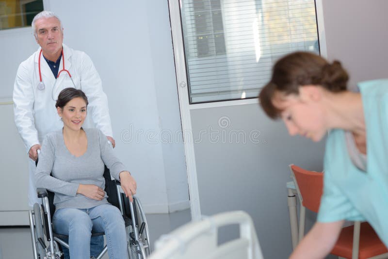 Doctor Pushing Patient in Wheelchair Stock Photo - Image of nurse ...