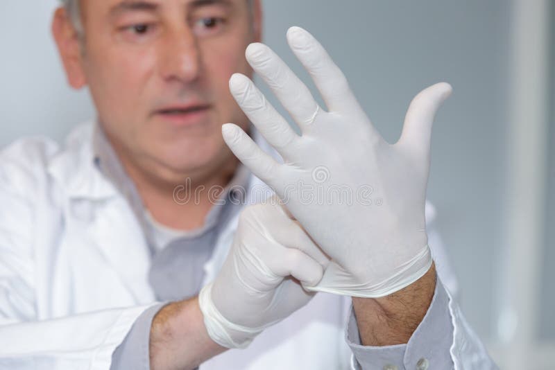 Doctor puts glove on hand stock photo. Image of operating - 103622252