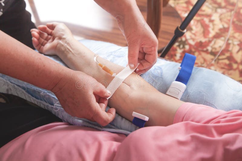 Doctor Putting Intravenous Drip into Patient Arm at Home Stock Image ...