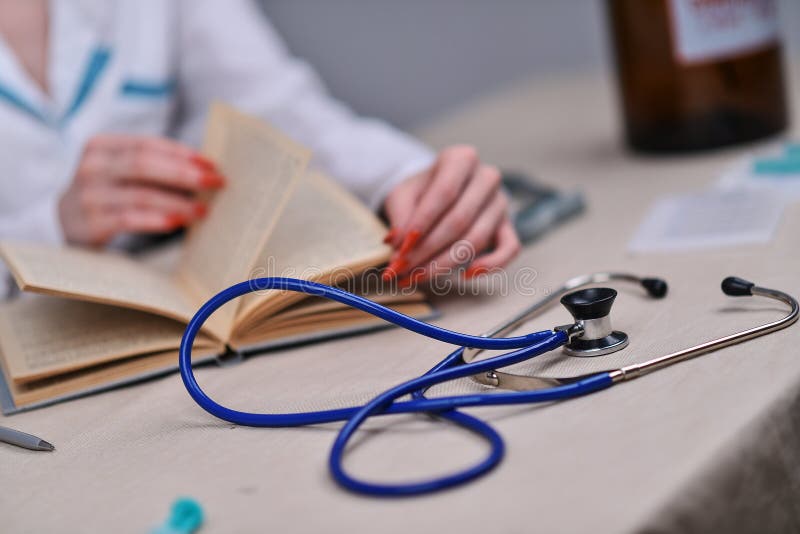 Doctor Reading a Book at the Table Stock Photo - Image of clinical ...