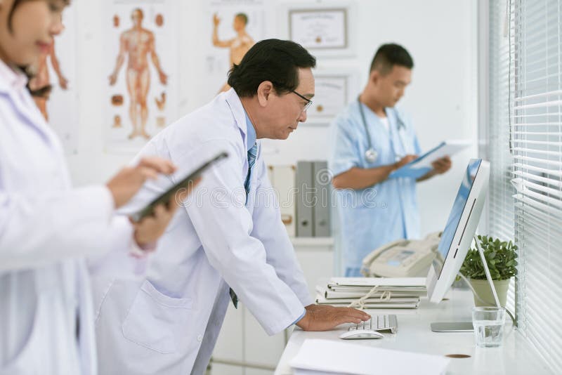 Doctor Reading Data on Computer Screen Stock Image - Image of health ...