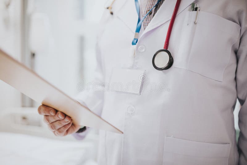 Doctor Reading a Patients Medical Chart Stock Photo - Image of care ...