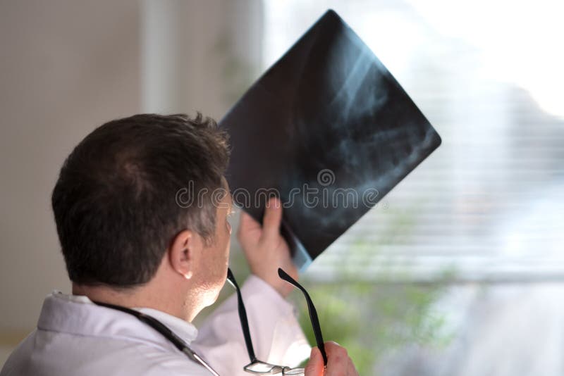 Doctor Reading X-ray Images Stock Image - Image of person, looking ...