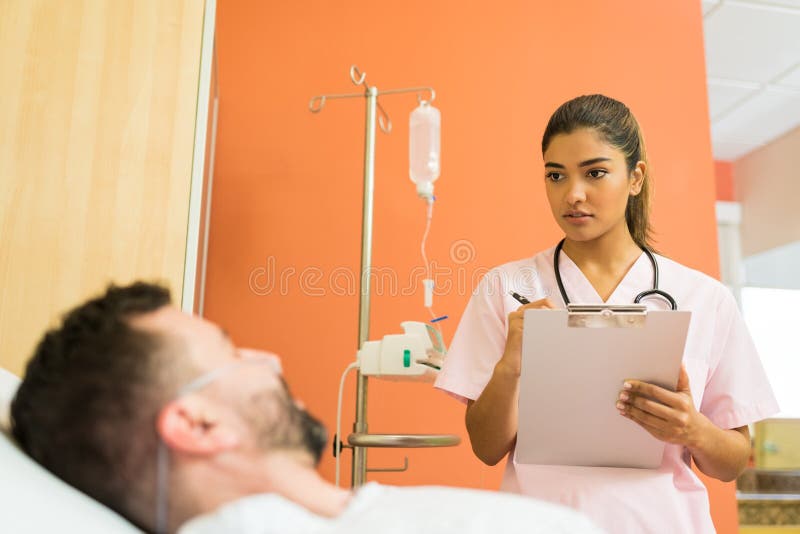 Doctor Reading Reports To Patient at Hospital Stock Photo - Image of ...