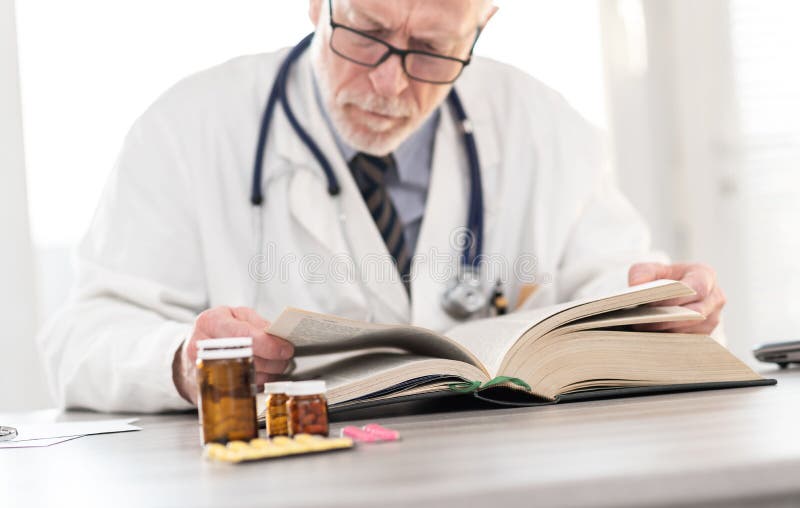 Doctor reading a textbook stock image. Image of uniform - 148134119