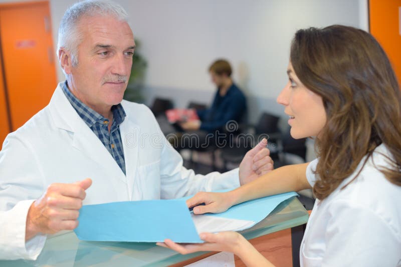 Doctor Receptionist Looking Files Stock Photos - Free & Royalty-Free ...