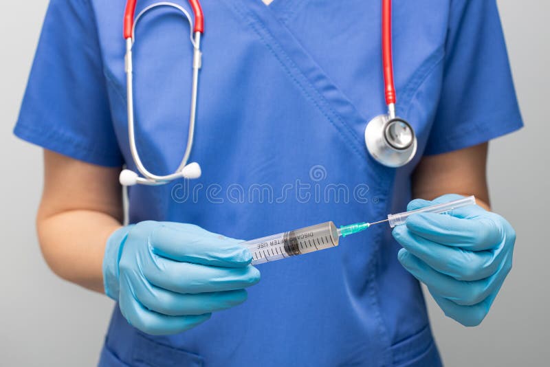 The Doctor Removes the Cap from the Syringe Stock Image - Image of mask ...