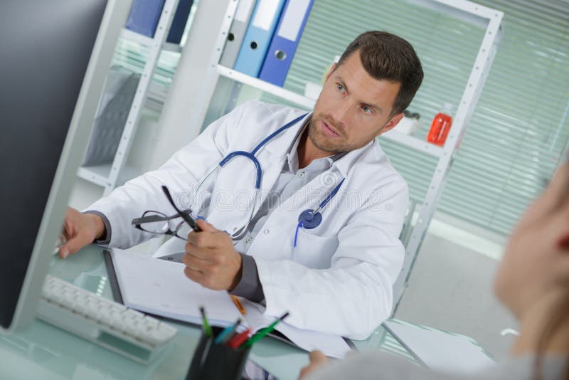 Doctor Reviewing Condition File Stock Photo - Image of supervisor ...