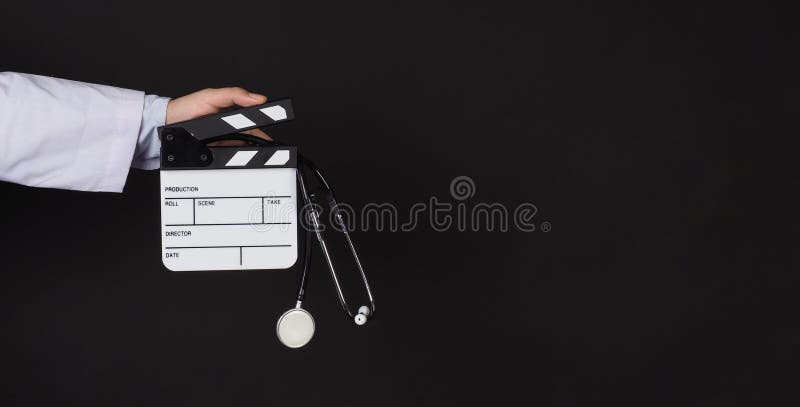Doctor S Hand Holding Stethoscope and Clapper Board on Black Background ...