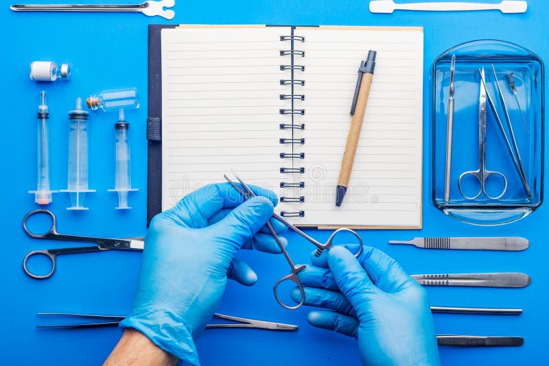Doctor S Hands, Notebook, and Medical Instruments on Blue Background ...
