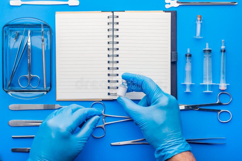 Doctor S Hands, Notebook, and Medical Instruments on Blue Background ...