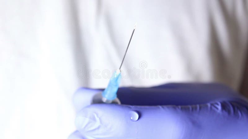 Doctor`s Hands Release Excess Air from the Syringe, Preparing for the ...