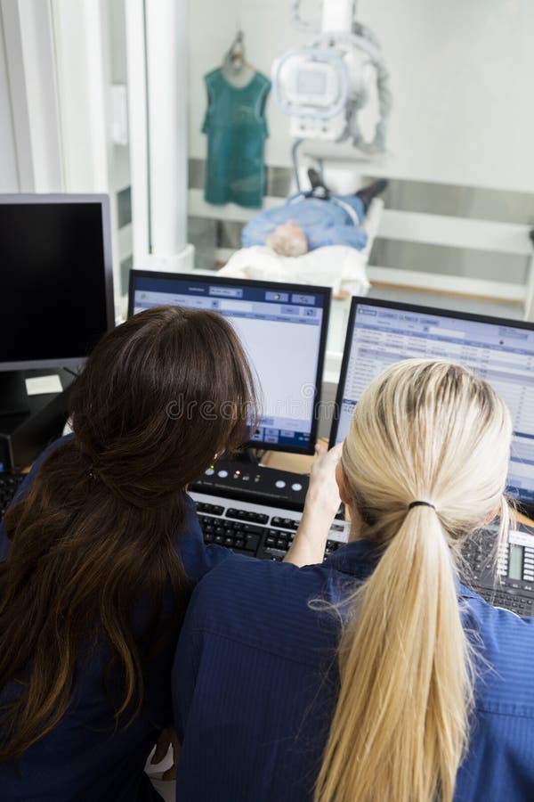 Doctor S Using Computers while Patient Lying Under Xray Machine Stock ...