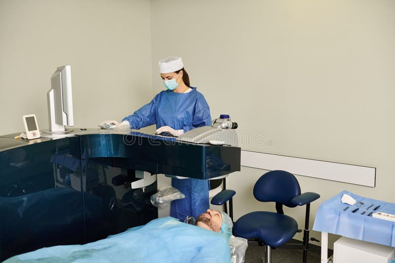 Doctor in Scrubs Performing Surgery Using Stock Photo - Image of screen ...