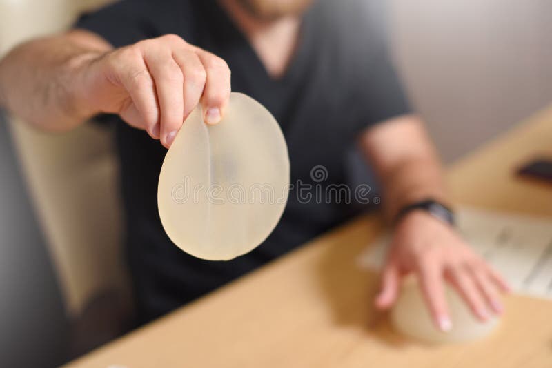 A Doctor Showing Breast Augmentation Implants in Her Hands Stock Image ...
