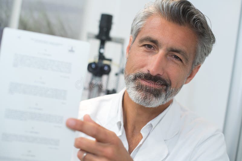 Doctor Showing Paper Eye Test Stock Photo - Image of optical ...