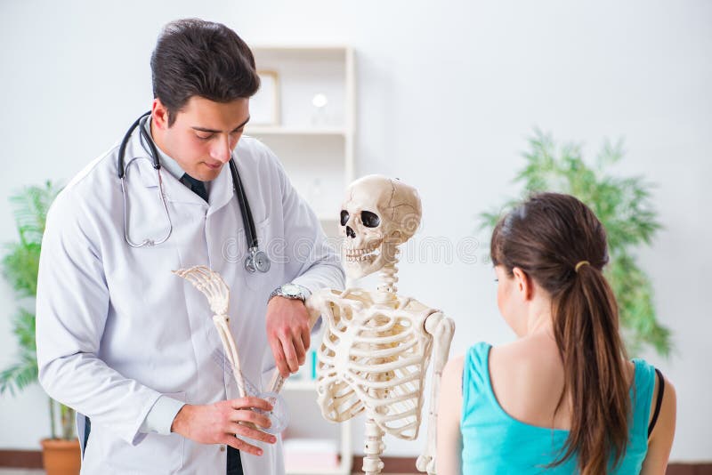 The Doctor Showing Type of Injury on Skeleton To Patient Stock Image ...