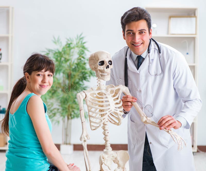 Doctor Showing Type of Injury on Skeleton To Patient Stock Photo ...