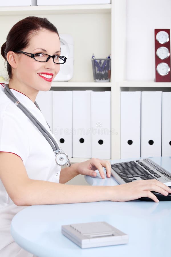 Doctor Sitting at the Desk with the Computer. Stock Image - Image of ...
