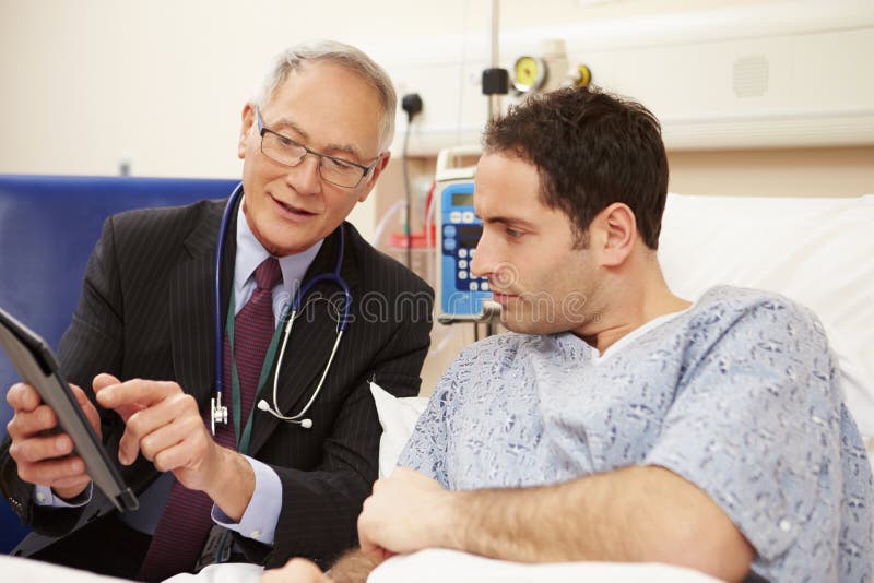 Doctor Sitting by Male Patient S Bed Using Digital Tablet Stock Photo ...