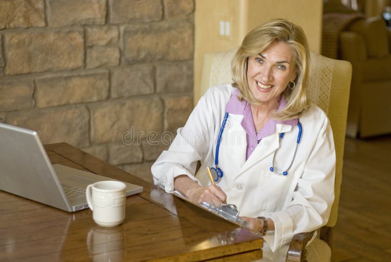 Doctor Sitting and Writing at Her Desk Stock Image - Image of doctor ...