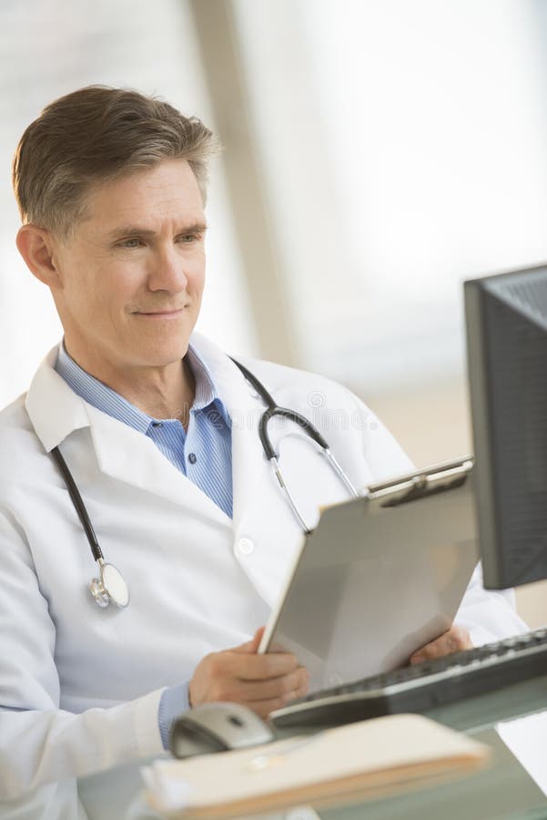 Doctor and Nurse Reviewing on Laptop Computer in O Stock Photo - Image ...