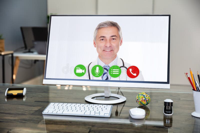 Doctor Smiling while Video Conferencing on Computer Stock Photo - Image ...