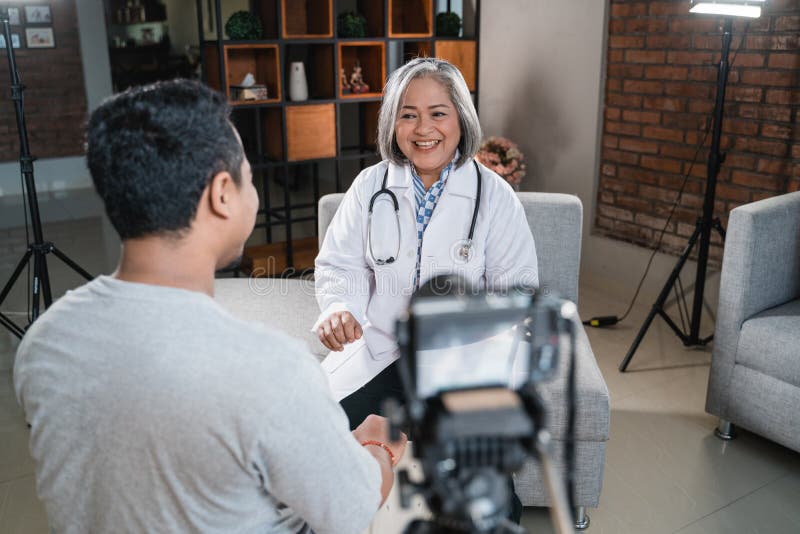 Doctor Speaking To the Patient and Recording with Camera Stock Image ...