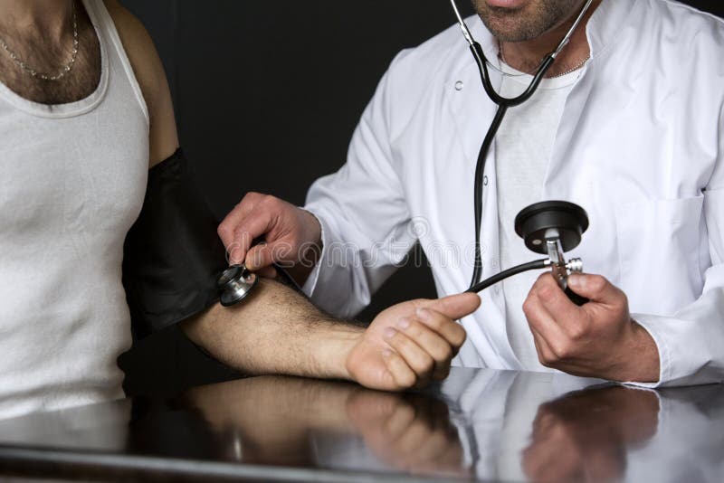 Doctor with Sphygmomanometer Checking Pulse from Patient Stock Photo ...