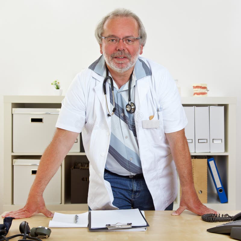 Doctor stands behind desk stock photo. Image of consultation - 194938250