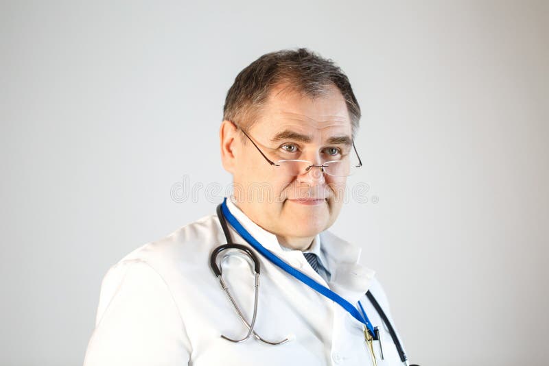 The Doctor Looks in Front of Him, he`s Wearing a White Coat and a ...