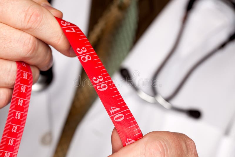 Doctor with Stethoscope Holding Measuring Tape Stock Image - Image of ...