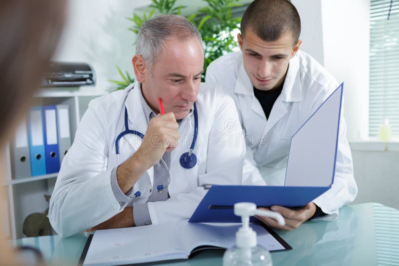 Doctor and Student Doctor Explaining Something Stock Image - Image of ...