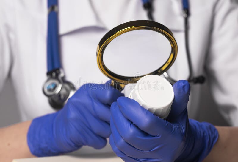 Doctor Studying Jar Pf Pills with Magnifier Stock Photo - Image of ...