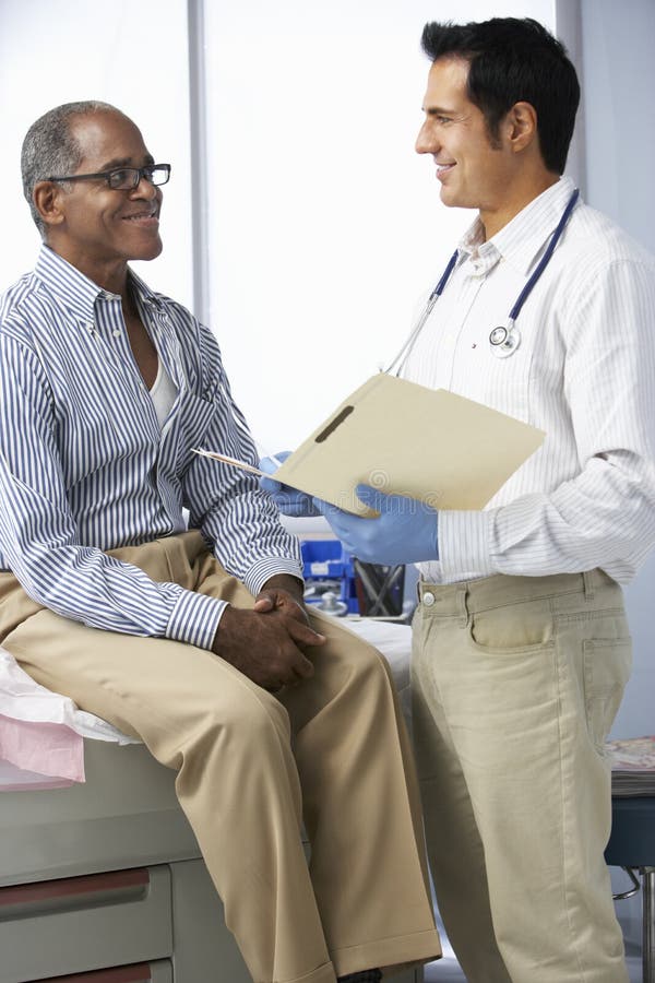 Doctor in Surgery with Male Patient Reading Notes Stock Image - Image ...